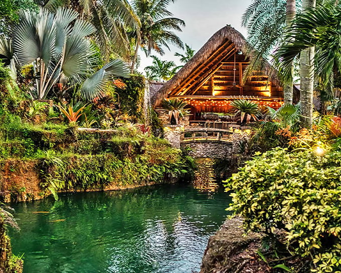 A tropical paradise awaits at Schnebly Winery, where thatched-roof structures and lush greenery create an oasis unlike any other winery you've visited.