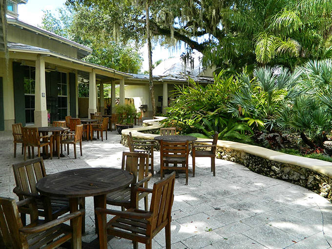 A tranquil oasis where wooden tables nestle among lush greenery, offering the perfect spot to refuel during your botanical adventure.