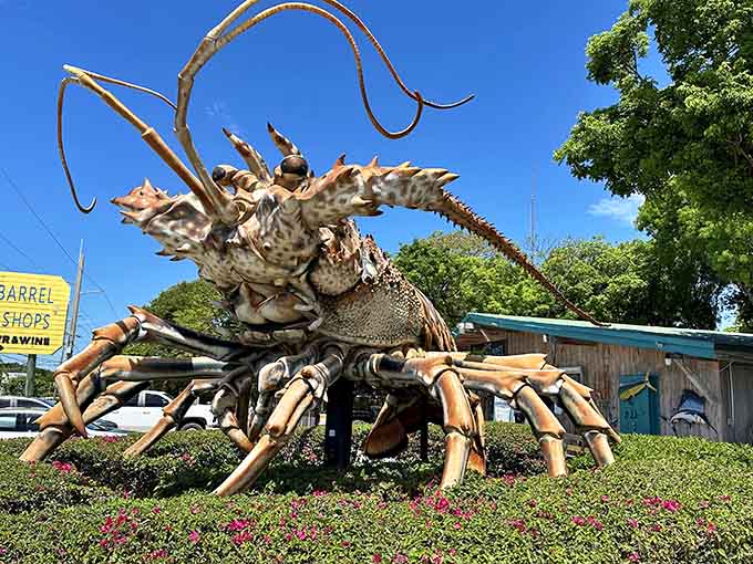 Betsy the Lobster stands guard like a crustacean colossus, her antennae reaching skyward as if testing the tropical breeze for approaching seafood lovers.