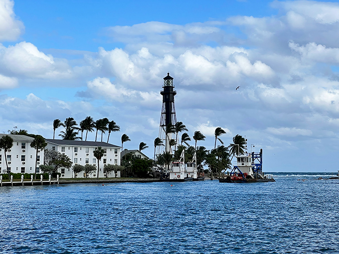 Where sky meets sea, this black and white sentinel has been Florida's coastal guardian since 1907, standing tall against azure waters and swaying palms.