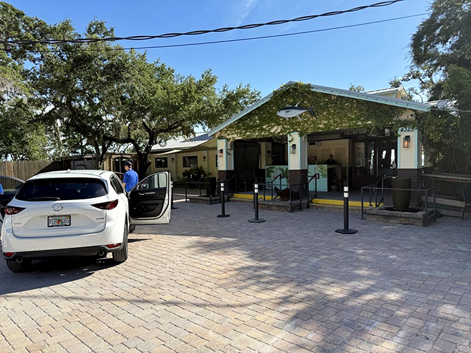 Welcome to paradise: Cap's On the Water's inviting entrance promises seafood delights under the shade of majestic Florida oaks.