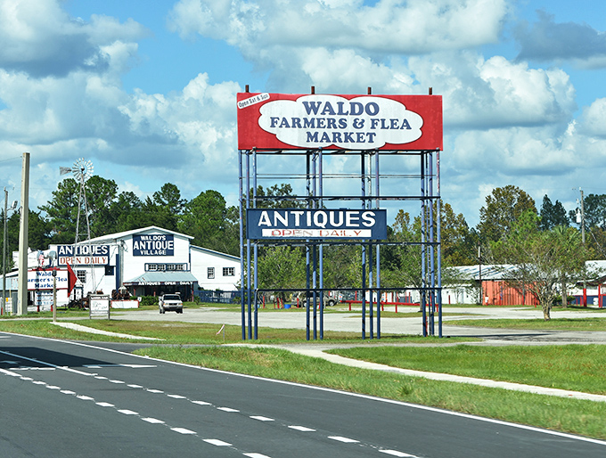 The iconic red and blue Waldo Farmers & Flea Market sign stands tall along US-301, a beacon for treasure hunters and bargain seekers traveling through north-central Florida.