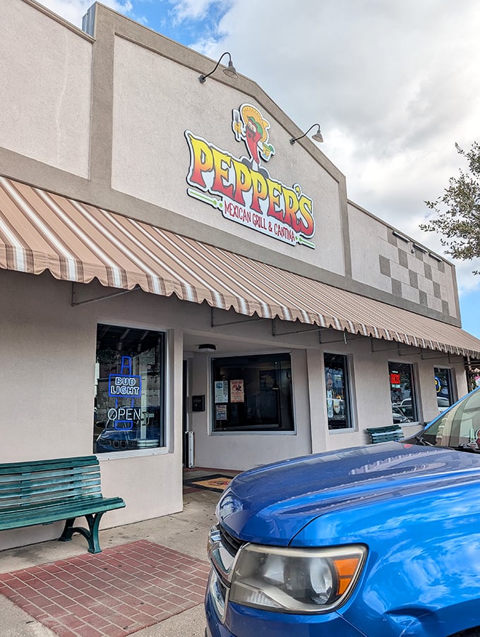 That cheerful pepper mascot on the sign knows something you don't yet: the best Mexican food in Leesburg is waiting just beyond that striped awning.