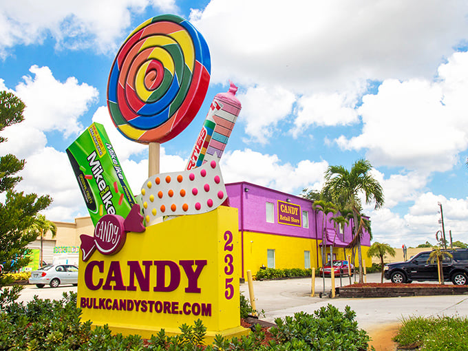 A candy lover's beacon: The vibrant purple and yellow building with its giant lollipop sign promises sweet adventures inside.