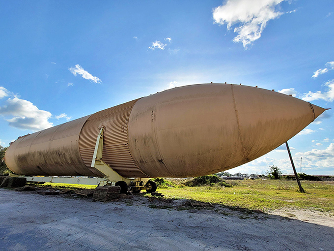 The tank's cylindrical perfection creates a striking silhouette against the landscape. From this angle, you can almost imagine it preparing for vertical installation.