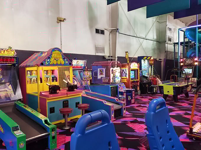 Classic arcade games stand in colorful rows, their screens glowing with digital promises of high scores and bragging rights.