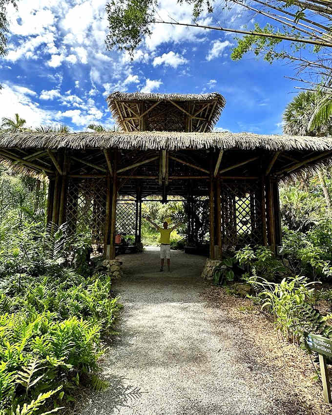 This thatched-roof structure stands like a tropical mirage among the palms, offering shade and a moment of zen-like tranquility.
