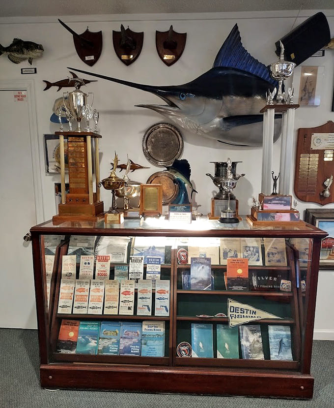 Tournament trophies and mounted catches celebrate the competitive spirit that defined Destin's fishing culture.