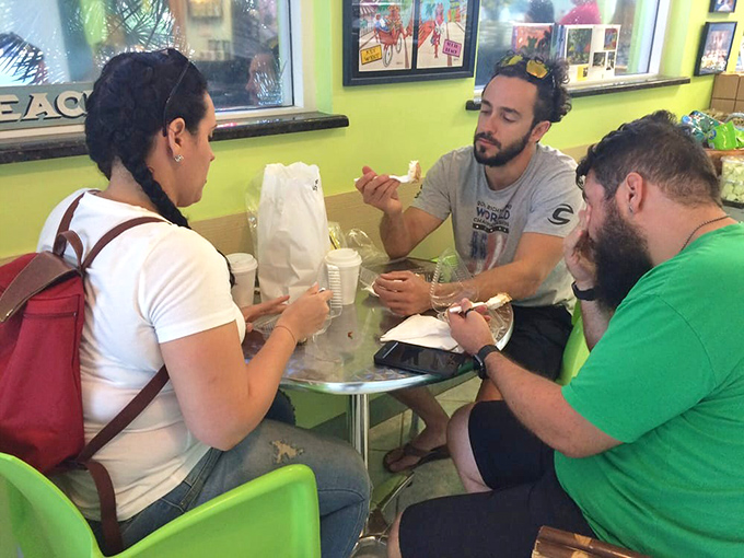 Visitors gather around a table to experience the communal joy of that first transcendent bite of authentic Key lime pie.