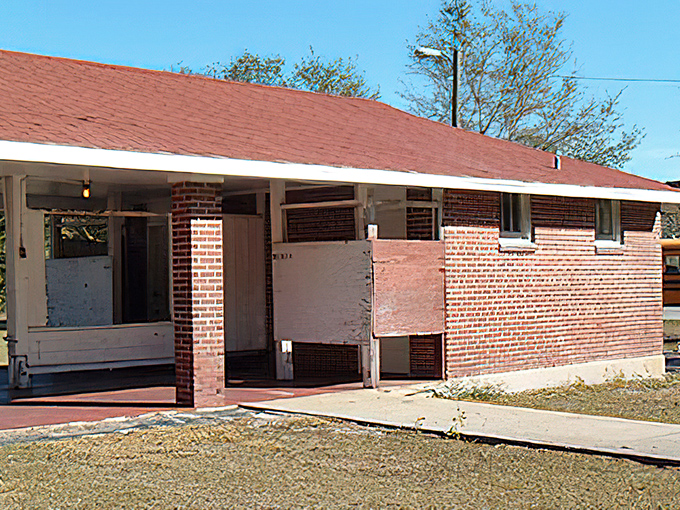 The modest brick facilities building complements the main structure, maintaining the architectural integrity of this historic campus.