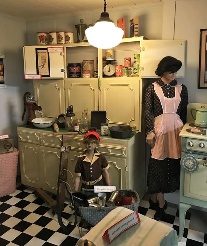 Period-appropriate kitchen items fill this vintage cupboard, reminding us how much effort went into preparing even simple family meals.