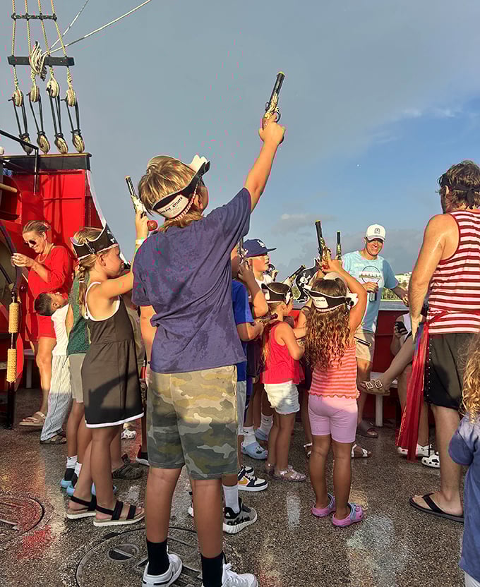 Junior pirates take aim with water cannons, their laughter carrying across the waves like the most joyful of pirate shanties.