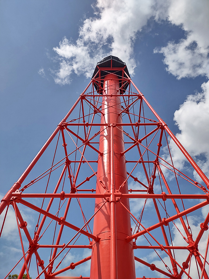 Low-Angle Capture: Looking skyward, the geometric precision of iron latticework creates a red web against Florida's perfect blue canvas.