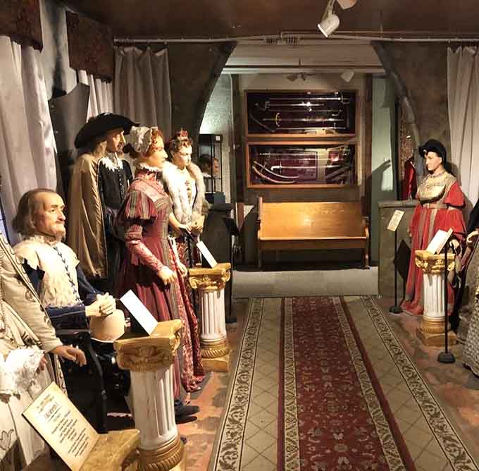 Period-dressed figures line this hallway like they're waiting for a Renaissance fair that's running fashionably late, about five centuries late.