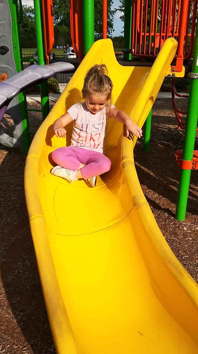 Bright yellow slides promise thrills without spills, though the occasional tumble just adds character to an otherwise perfect afternoon.
