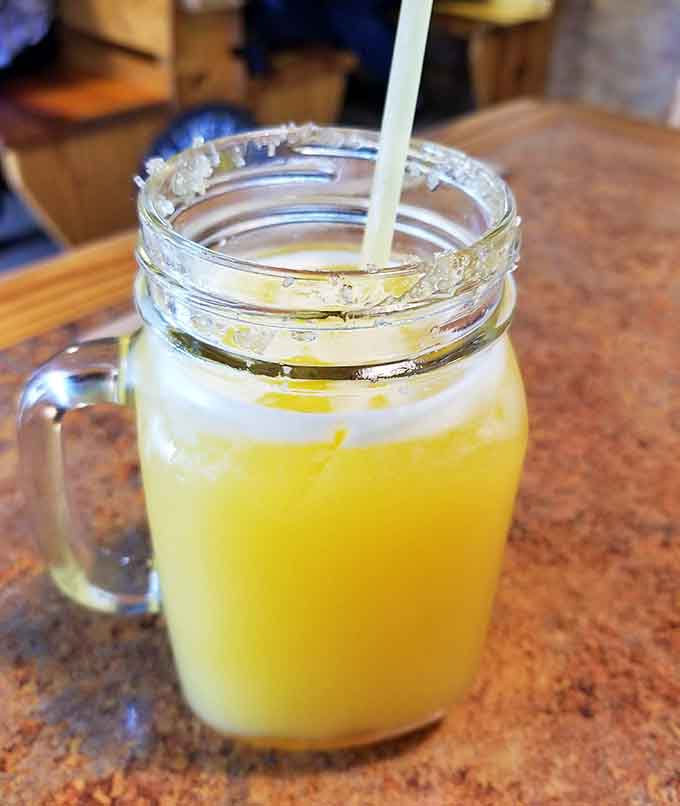 Fresh-squeezed orange juice capturing Florida sunshine in a mason jar, because even beverages here embrace that down-home aesthetic.
