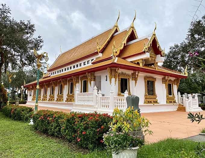 Twin serpents frame the temple entrance, their green scales and fierce expressions welcoming visitors to this sacred space.