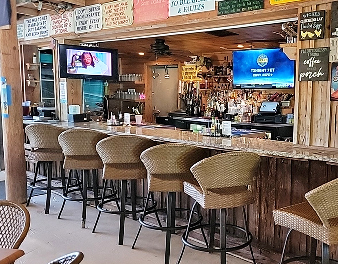 A bar that says "pull up a stool and stay awhile." The wooden backdrop and wicker chairs whisper tales of countless happy hours and local legends.