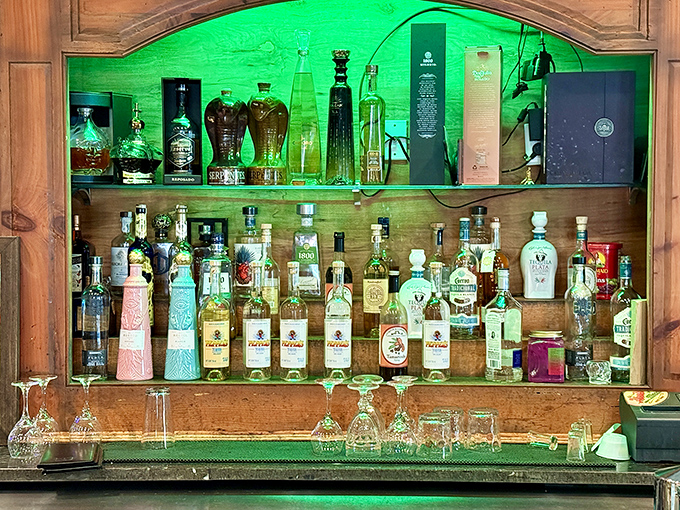 This bar setup with its backlit tequila display and multiple screens makes you want to pull up a stool even if you weren't thirsty.