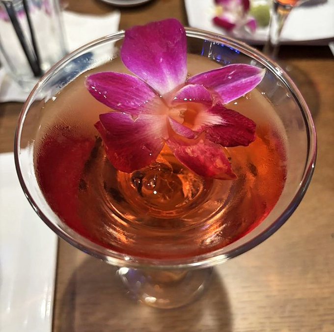 That's not just a drink &ndash; it's a tiny swimming pool for the orchid floating on top, bringing tropical vacation vibes with every sip.