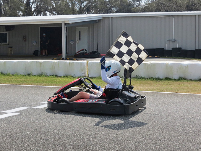 Victory never tasted so sweet! This triumphant racer celebrates with the checkered flag, having earned bragging rights until at least next weekend.