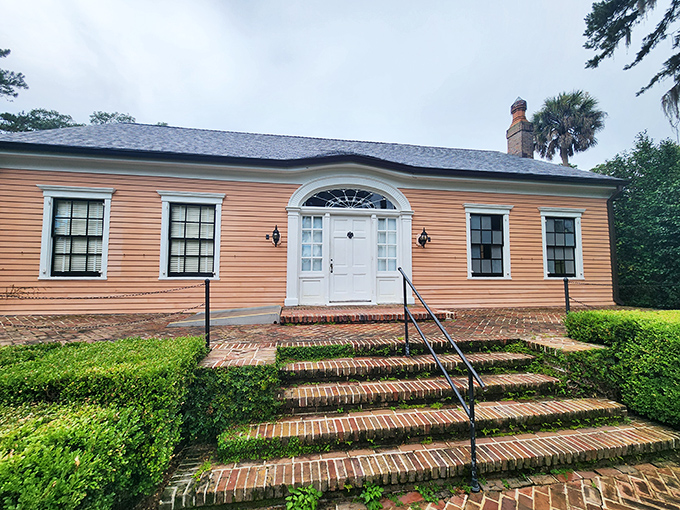 The historic Maclay House stands as a testament to old Florida elegance, its warm orange exterior glowing in the afternoon light.