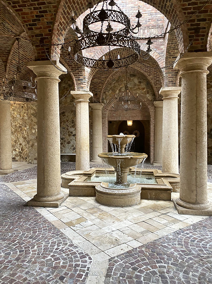 Arched colonnades frame a central fountain, creating a space where even checking your email somehow feels like a Renaissance activity.
