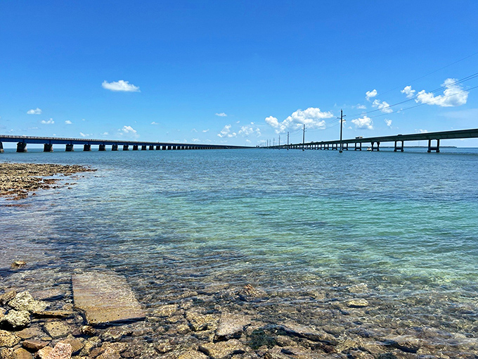 Two generations of engineering ingenuity run parallel – the modern highway carrying hurried travelers while its predecessor invites contemplative exploration.