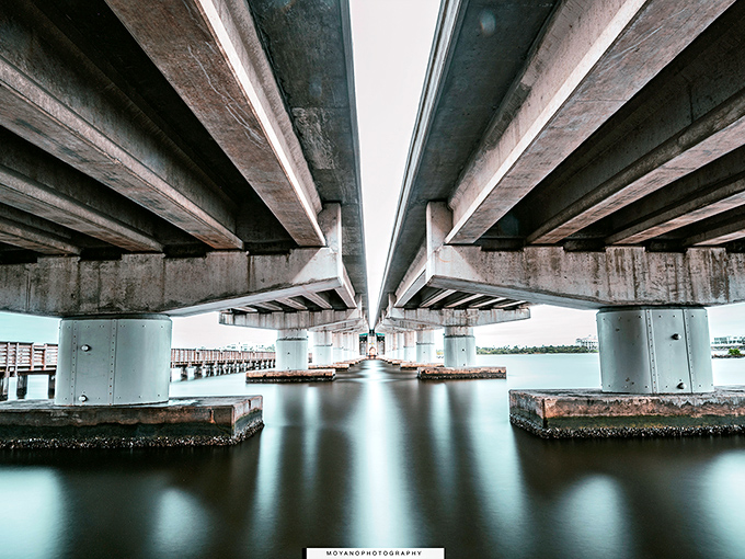 Underneath the Lake Worth Bridge reveals a geometric wonderland where engineering meets art, creating dramatic light patterns.