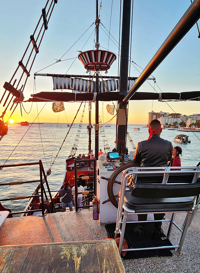 As the sun sets on another day of adventure, silhouettes on deck remind us that pirate dreams never truly fade.