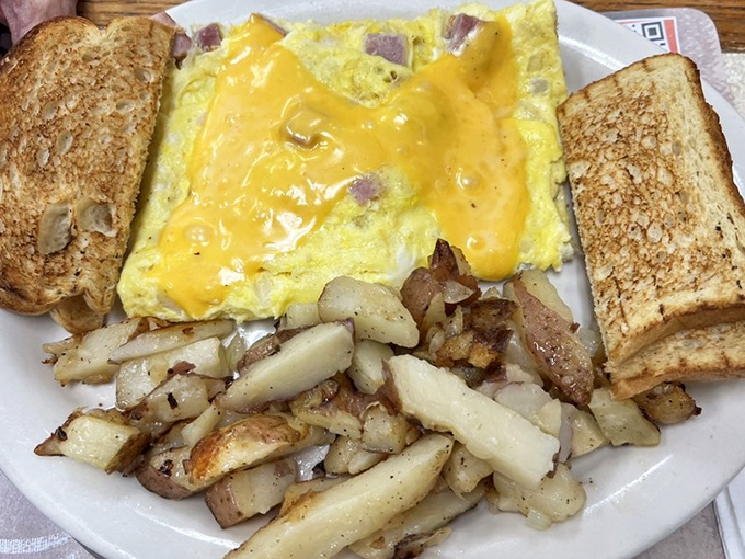 The Denver omelet arrives blanketed in country gravy &ndash; because sometimes breakfast should feel like a warm hug from the inside.