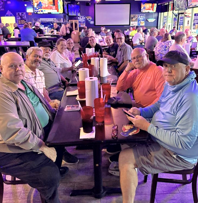 A gathering of wing enthusiasts sharing stories and sauce recommendations. Notice how nobody's looking at their phones—that's the power of great food.