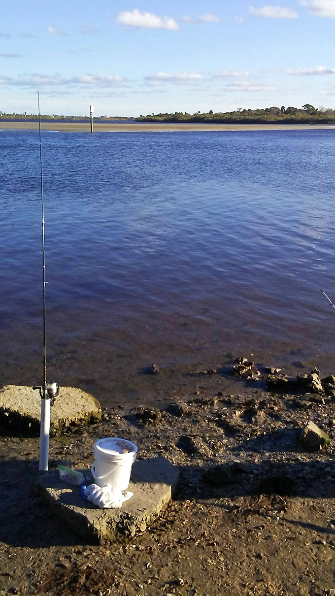 A fishing rod stands at attention against the backdrop of calm waters – the universal symbol for "out of office, please do not disturb."