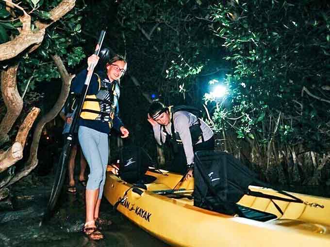 Excitement builds as night paddlers gather with their equipment, ready to discover one of Florida's most magical natural phenomena.
