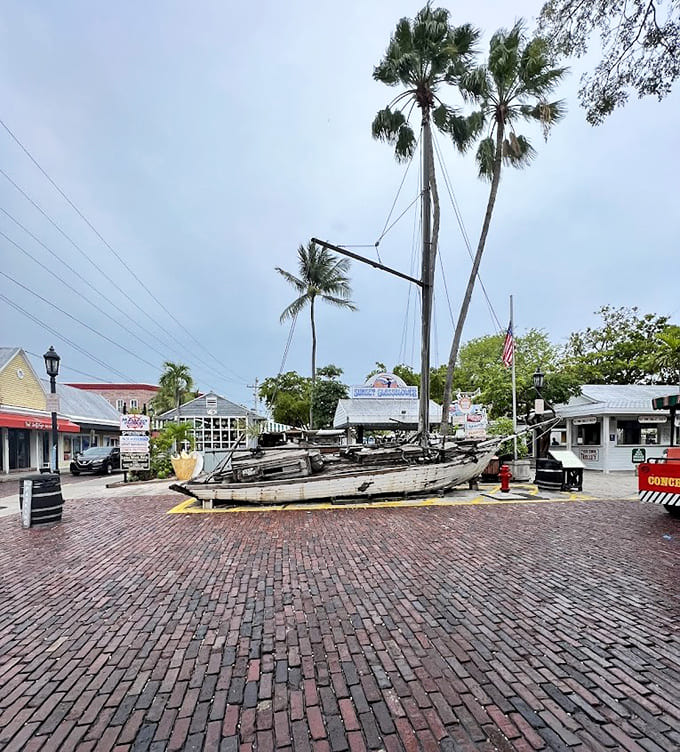 The weathered boat sits as a reminder that Key West's fortune was built on salvaging shipwrecks, the original "one person's trash" business model.