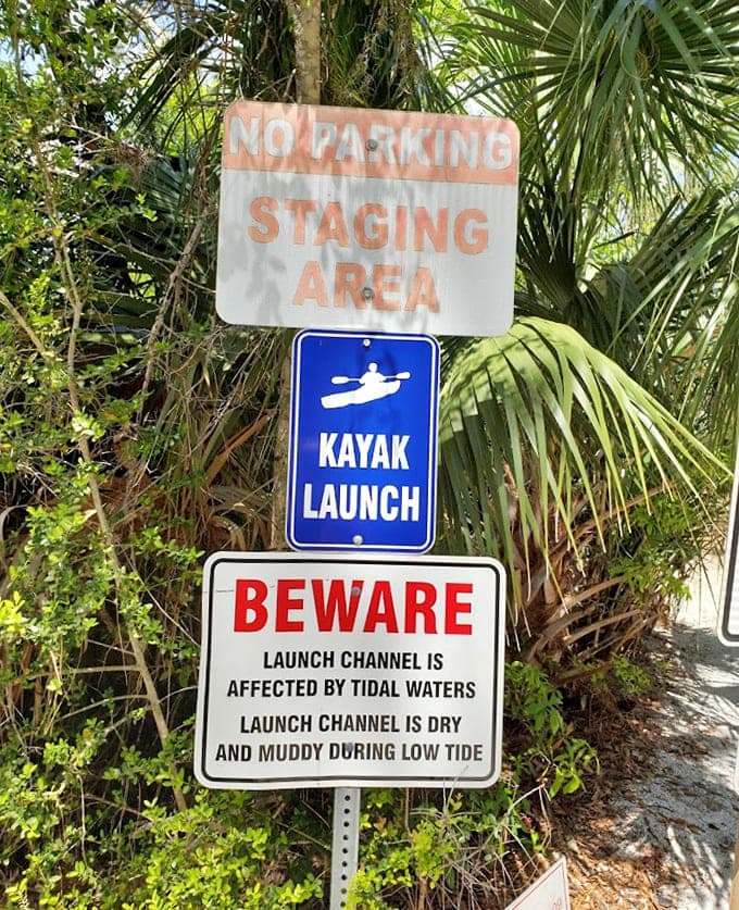 Signs remind kayakers that tides wait for no one, teaching patience to those who thought they could outsmart the moon.
