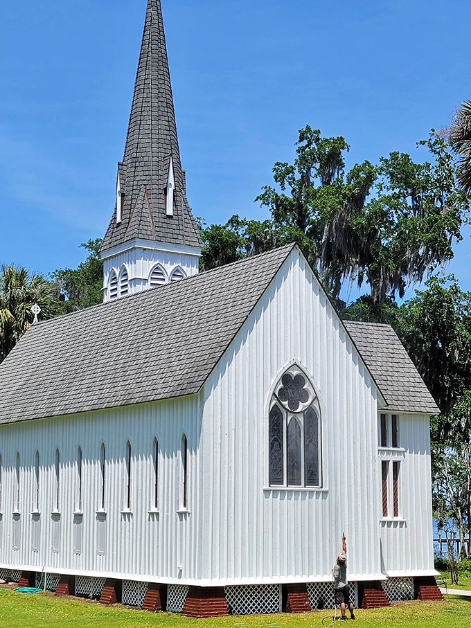St. Mary's Episcopal Church stands as a pristine white sentinel of faith, its spire reaching skyward through a canopy of Spanish moss.