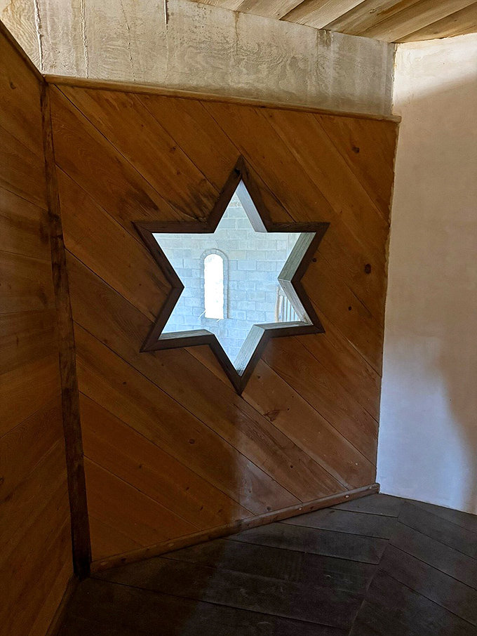 The Star of David window creates an unexpected geometric conversation between faiths within these Christian walls.