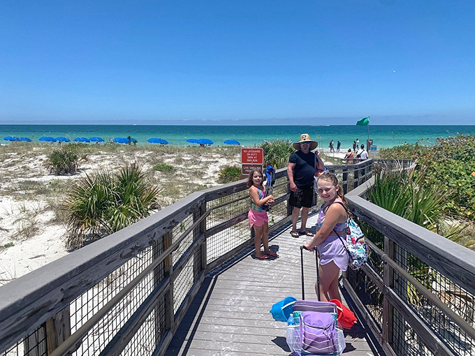 Visitors: Crossing the threshold to paradise, these beachgoers discover that the best souvenirs are the memories you can't pack.