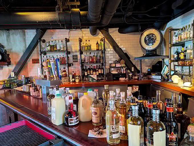 The bar area blends industrial elements with warm lighting, creating a space where mixologists craft drinks with the innovative spirit of Edison himself.