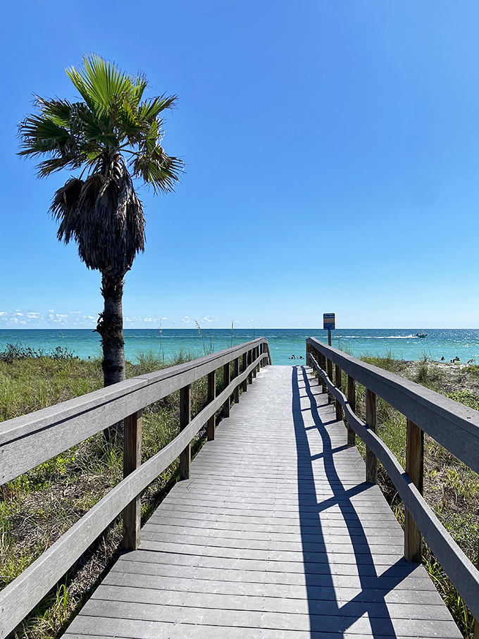The wooden boardwalk creates a perfect pathway to paradise, guiding visitors through sea oats to Treasure Island's welcoming waters.