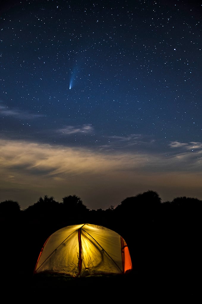 A glowing tent under a comet-streaked sky creates the perfect Florida postcard moment. Who needs resort amenities when you have this view?