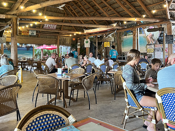 The thatched roof dining area isn't just charming&mdash;it's practically mandatory for the full Old Florida experience. Ceiling fans keep the stories flowing as freely as the drinks.