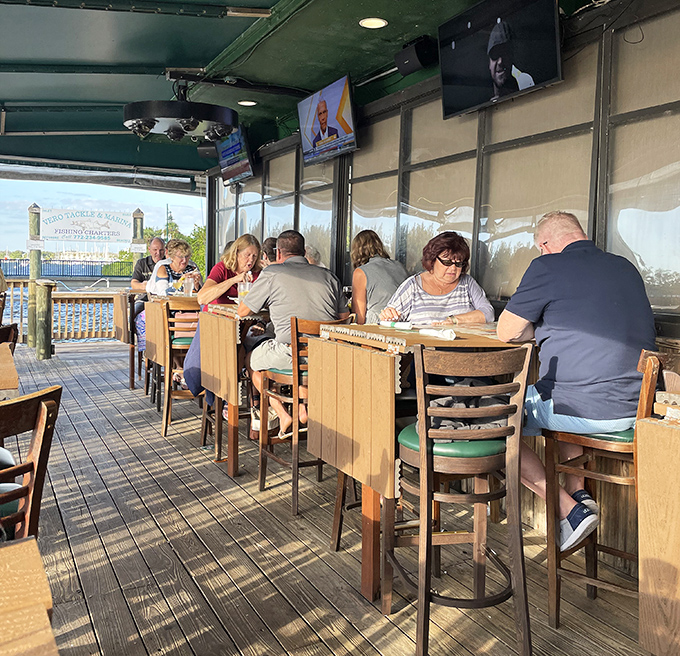 Outdoor dining with a view that no interior designer could create &ndash; just honest tables, happy diners, and the endless Florida sky as your ceiling.