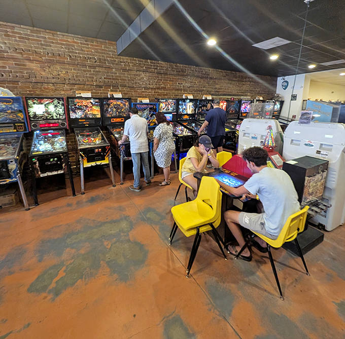 Exposed brick walls and classic cabinets create the perfect atmosphere for this interactive time capsule of electronic entertainment.
