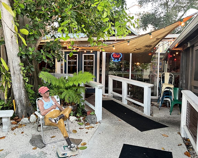 The quirky outdoor seating area features a statue that welcomes you to this hidden gem where seafood meets Southern comfort.