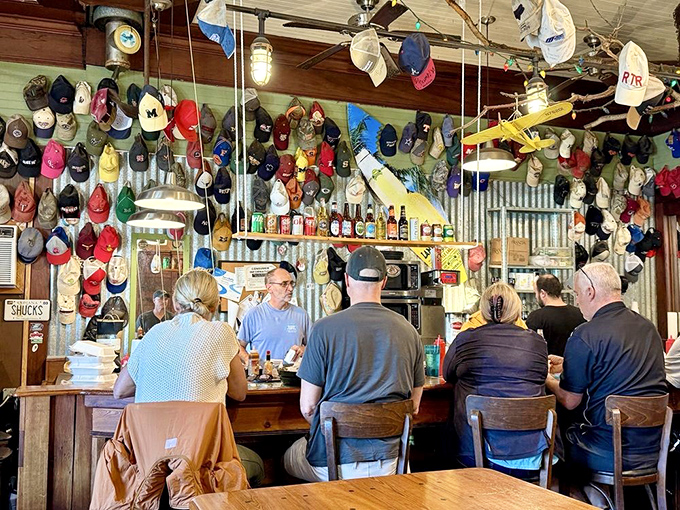 At the bar, baseball caps from around the world create a colorful canopy above patrons enjoying fresh catches.