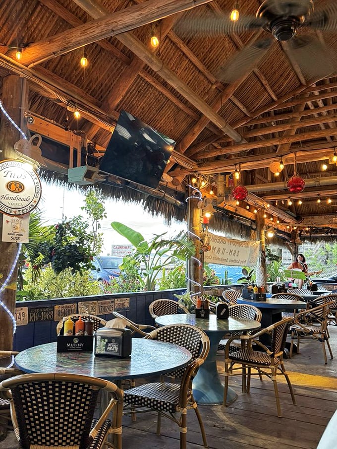 Beneath the thatched roof, ceiling fans stir tropical breezes while twinkling lights create the perfect atmosphere for making vacation memories.