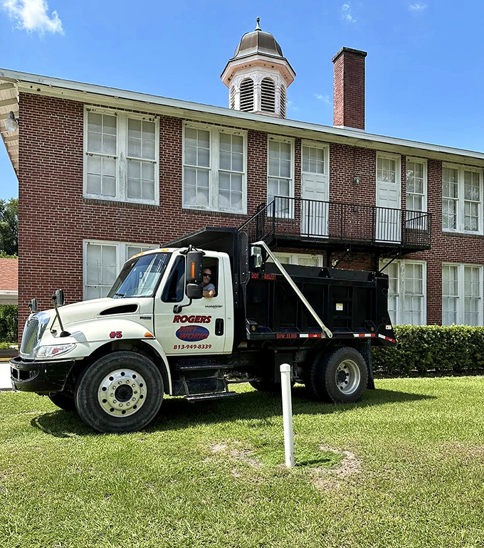Even maintenance vehicles seem to pause respectfully beside this venerable institution that has weathered nearly a century of Florida seasons.