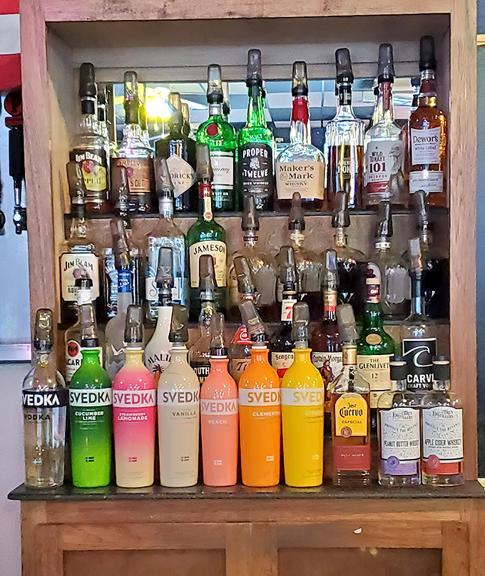 A rainbow of spirits standing at attention, ready to complement your wing adventure. The colorful Svedka bottles look like they're attending a flavor convention.